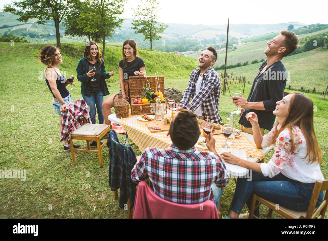 Group of young happy friends having pic-nic outdoors - People having ...