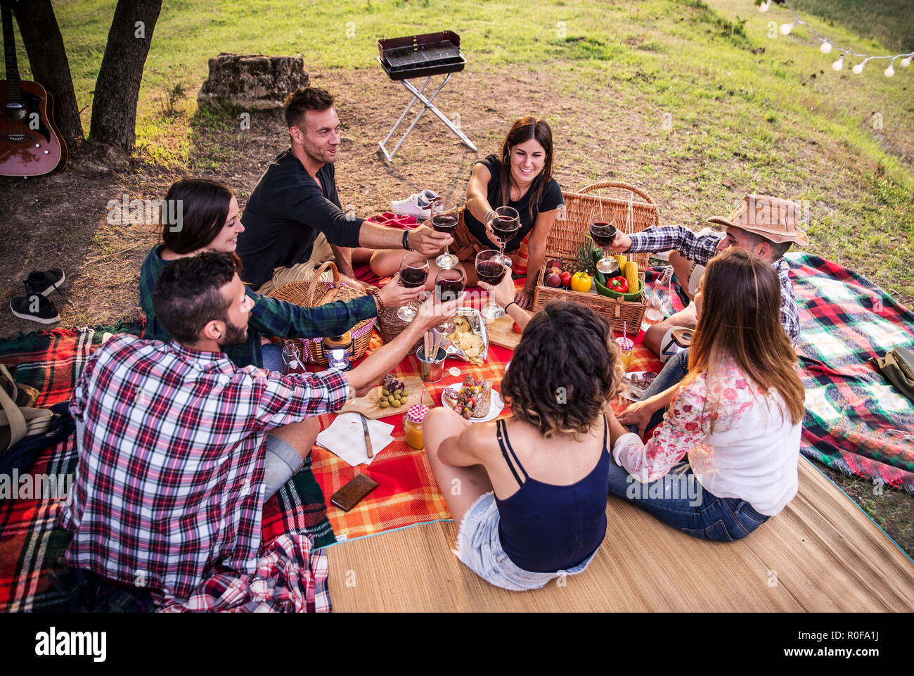 Group of young happy friends having pic-nic outdoors - People having ...