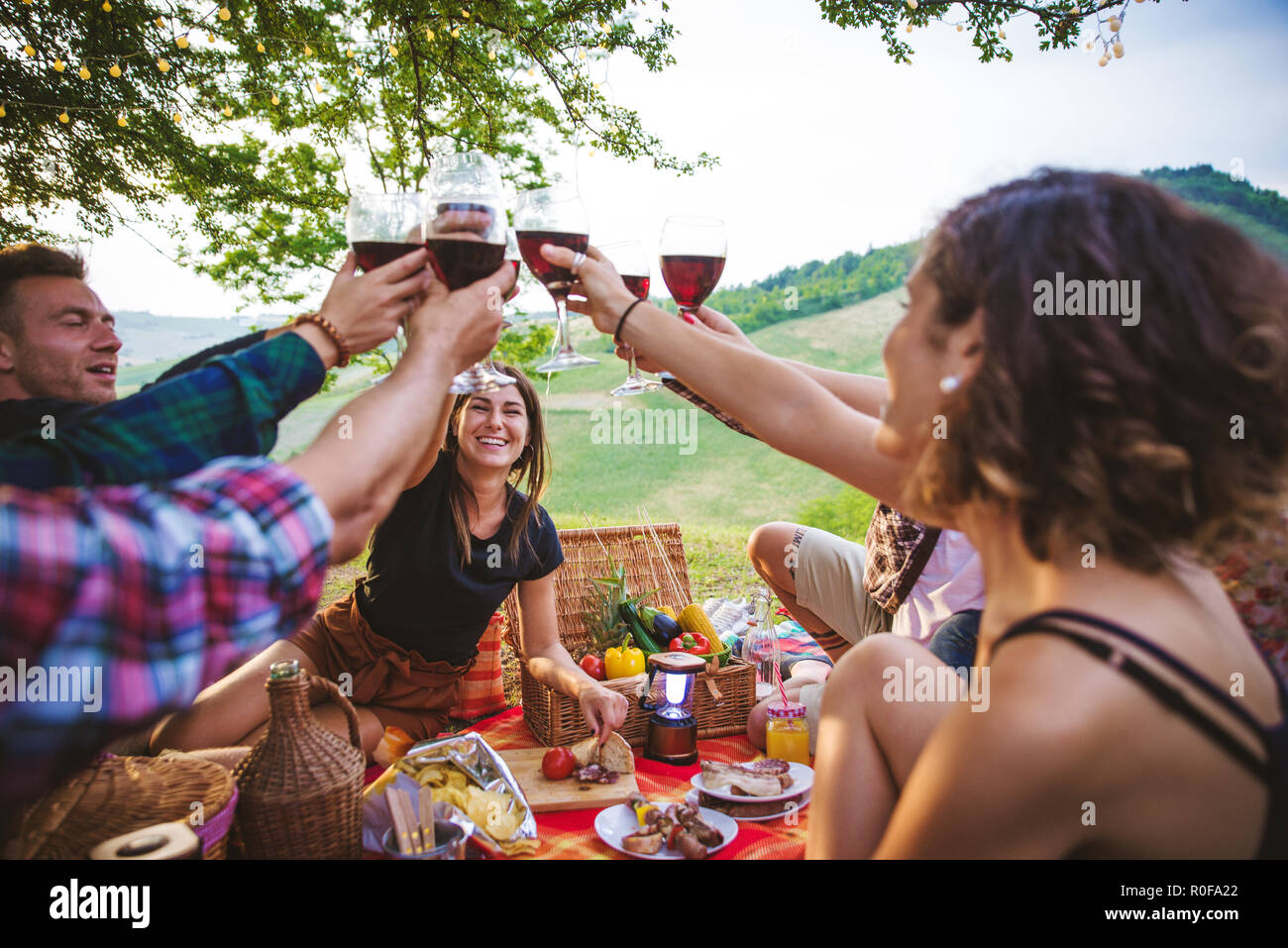 Group of young happy friends having pic-nic outdoors - People having ...