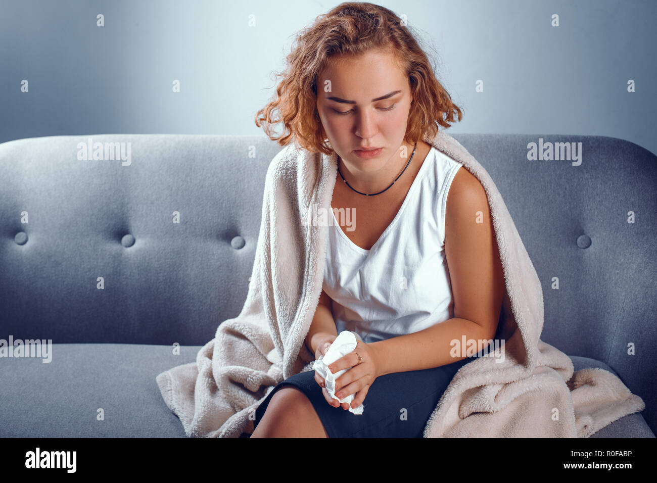 Sick woman holds a tissue Stock Photo - Alamy