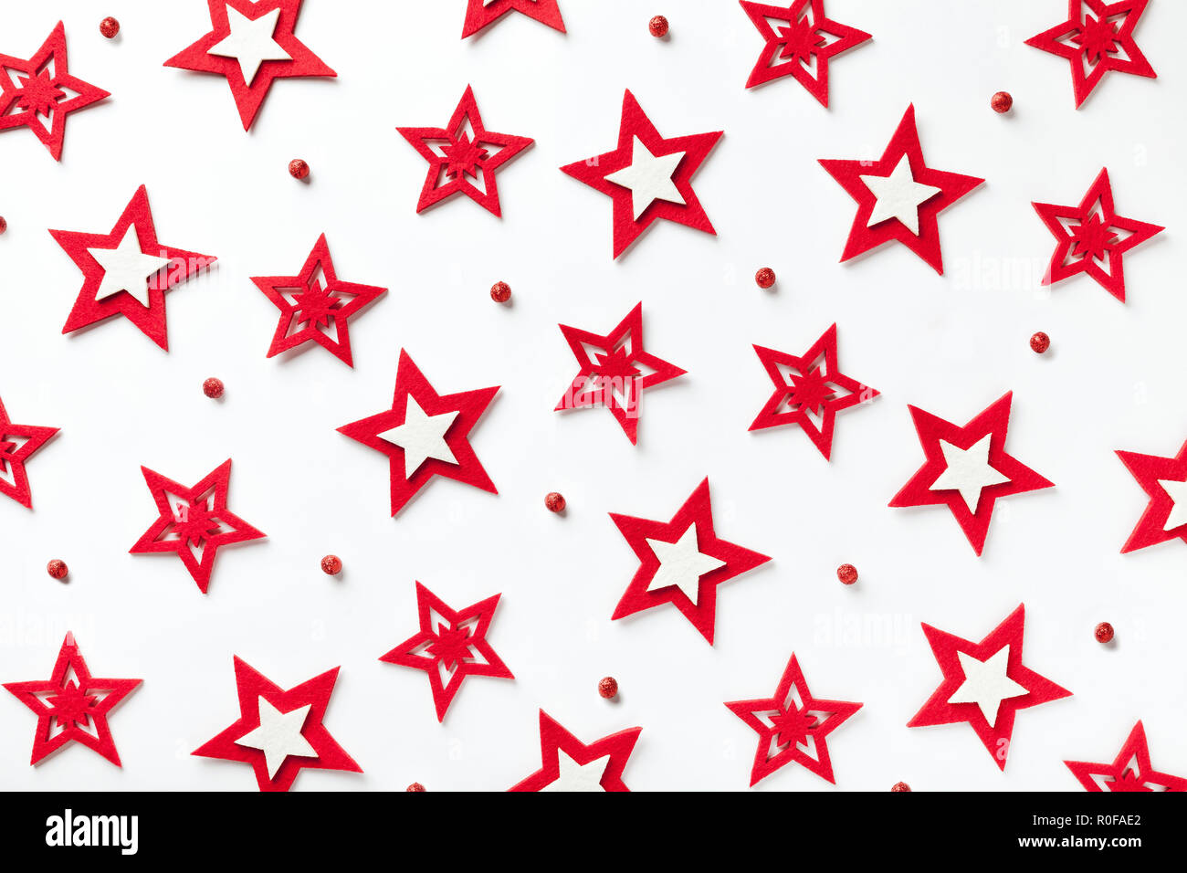 Christmas pattern of red stars on a white wooden background. Backdrop ...