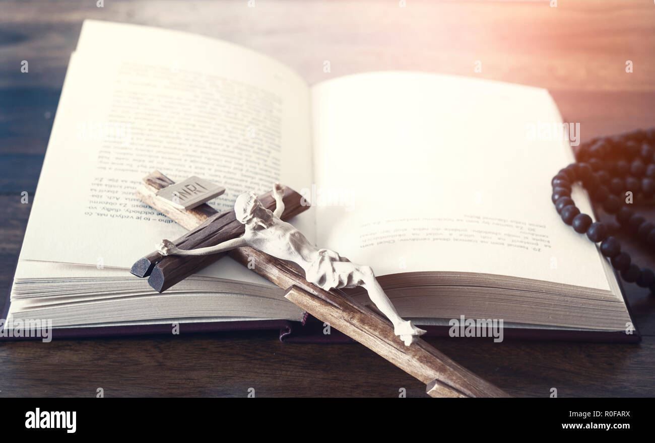 crucifix with Jesus Christ and holy bible book Stock Photo - Alamy