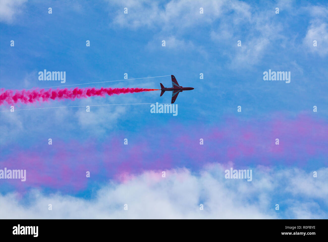 RAF Red Arrow Hawk displaying at Torbay Airshow Stock Photo - Alamy