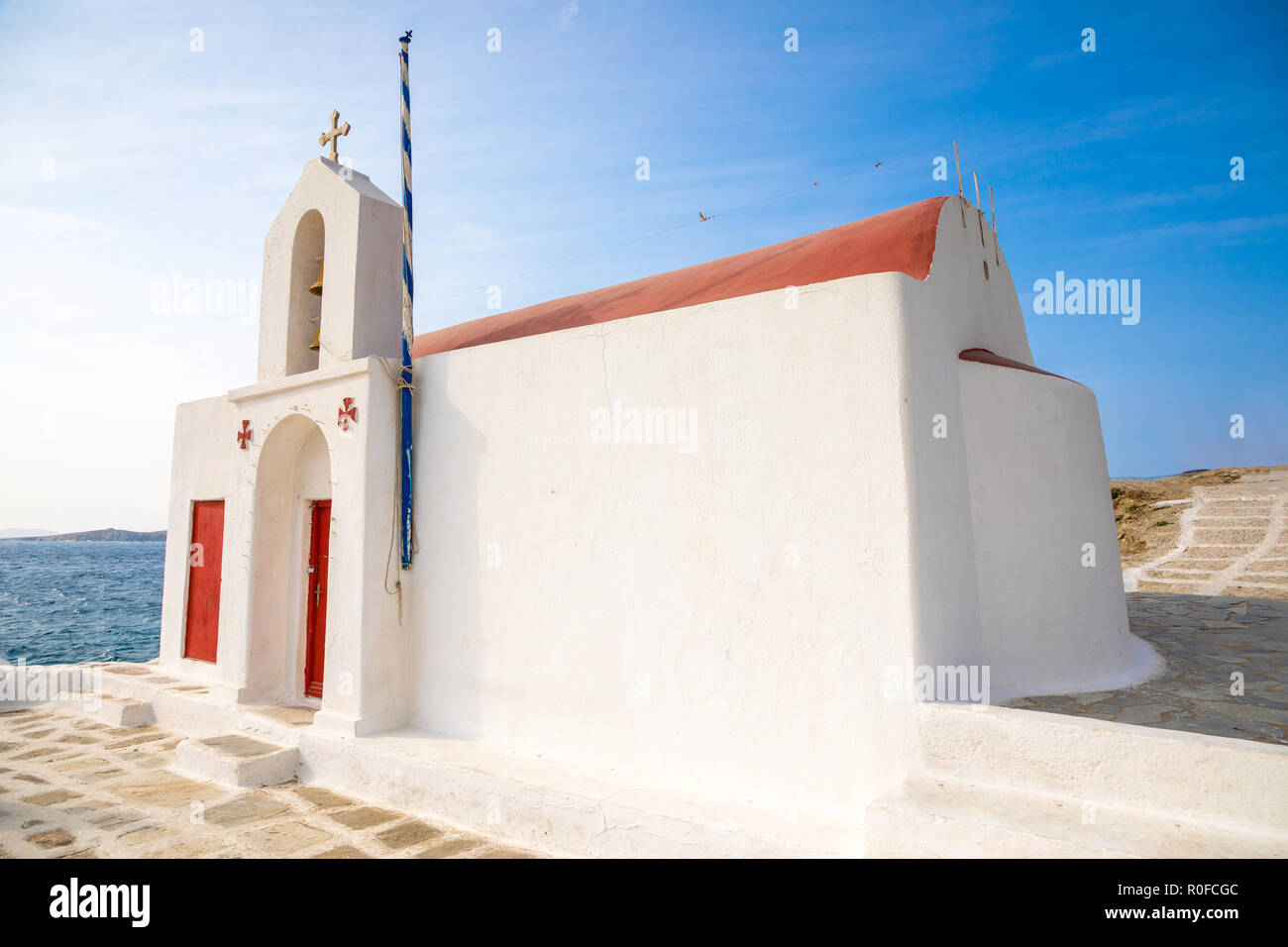 Typical Greek church white building with red dome against the blue sky ...
