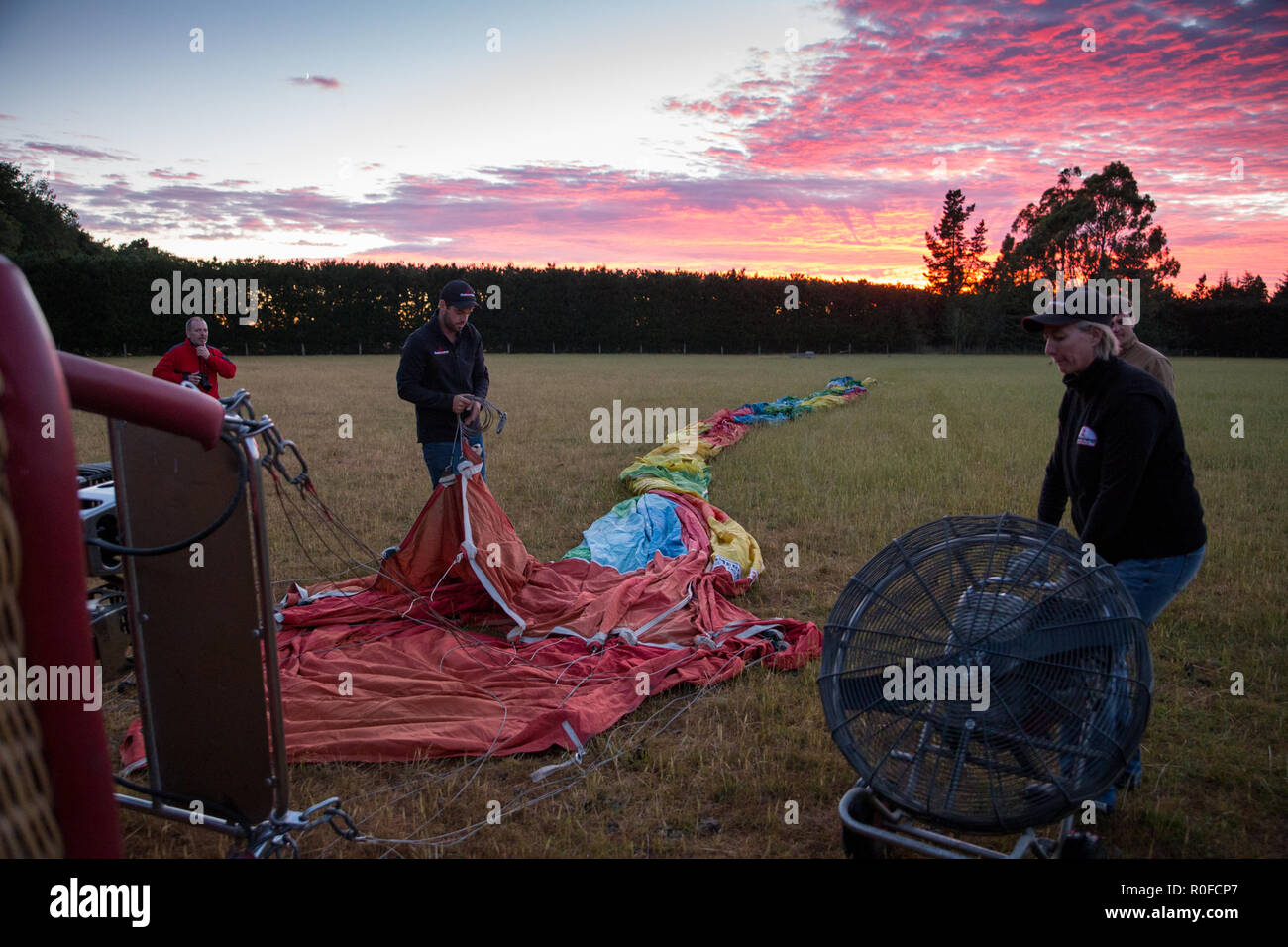 Staff prepare a hot air balloon for tourists going on an adventure at ...