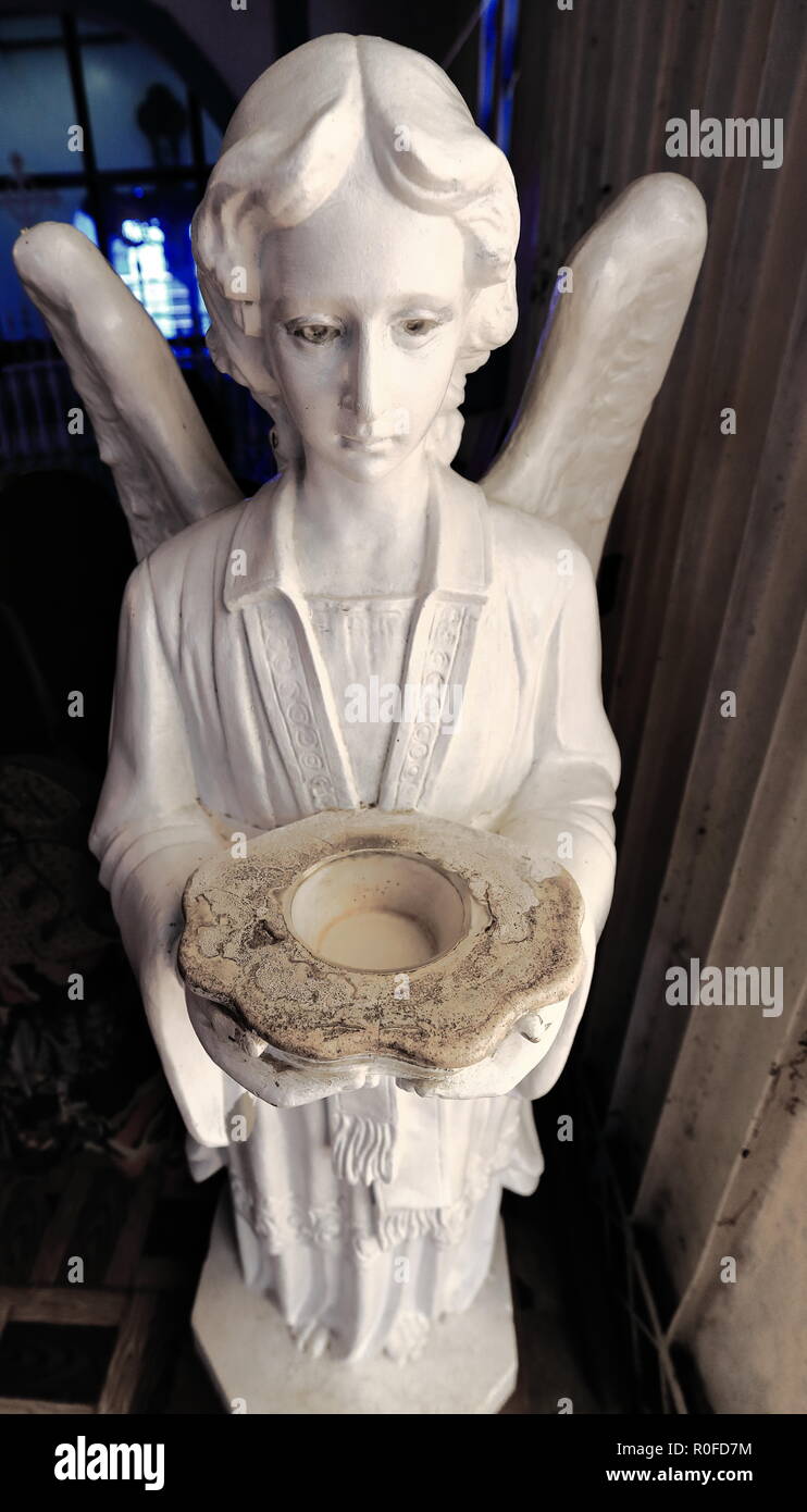 Angel sculpture serving as holy water fountain or stoup at the entry of ...