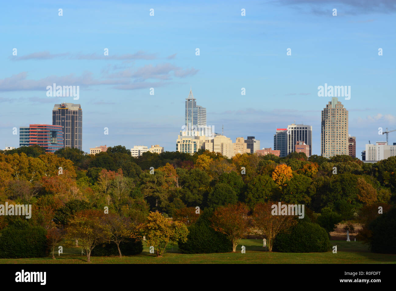 The downtown Raleigh NC skyline rises above autumn trees from the ...