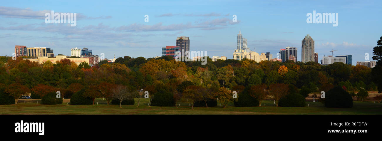 The downtown Raleigh NC skyline rises above autumn trees from the ...