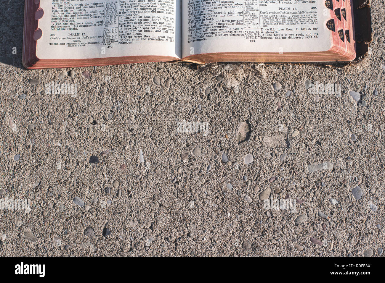 A bible lays open on a sidewalk Stock Photo - Alamy