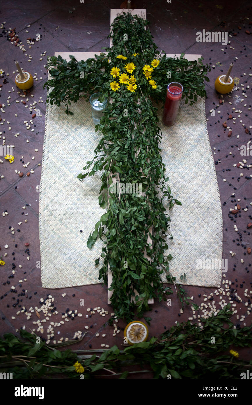 A green cross decorates an altar during Day of the Dead celebrations in ...