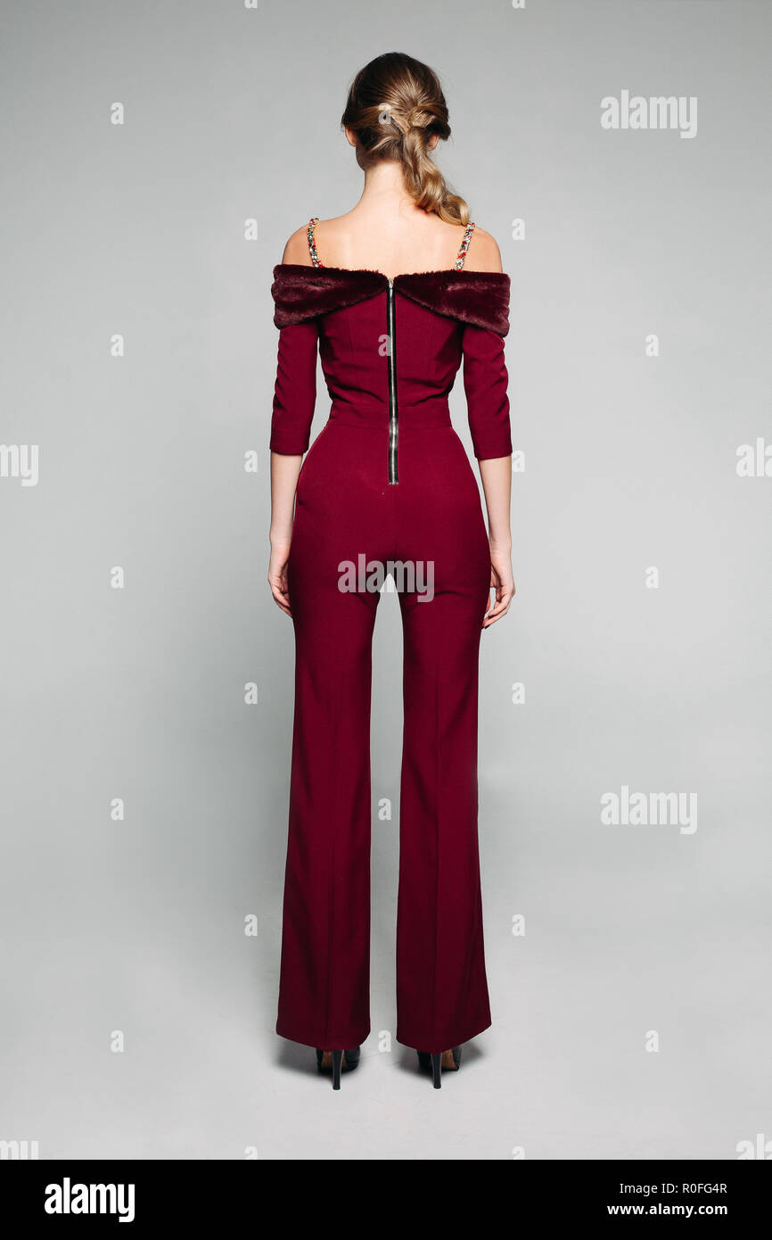 Unrecognizable model demonstrating red overall with bare shoulders ...