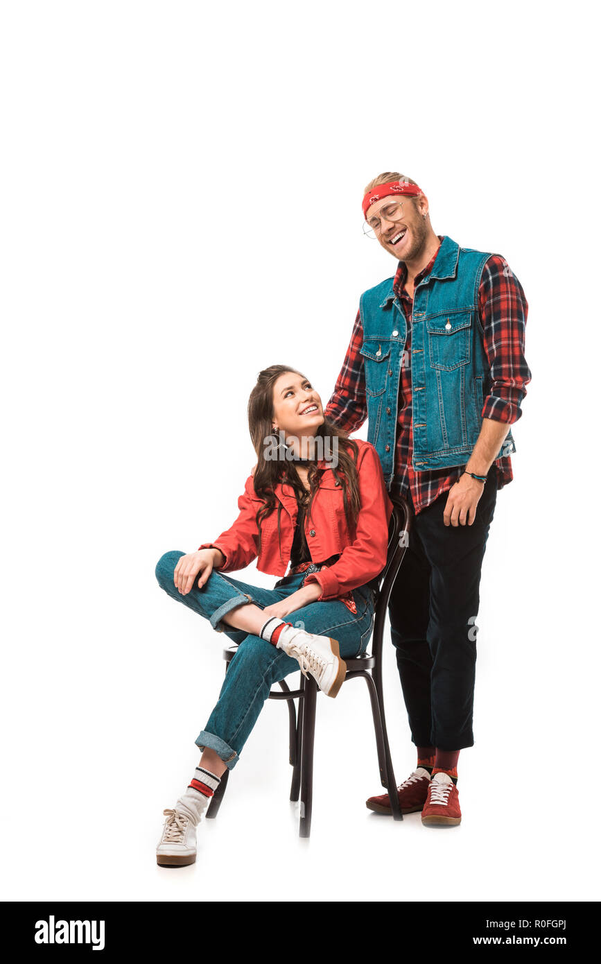attractive hipster girl sitting on chair while her smiling boyfriend ...