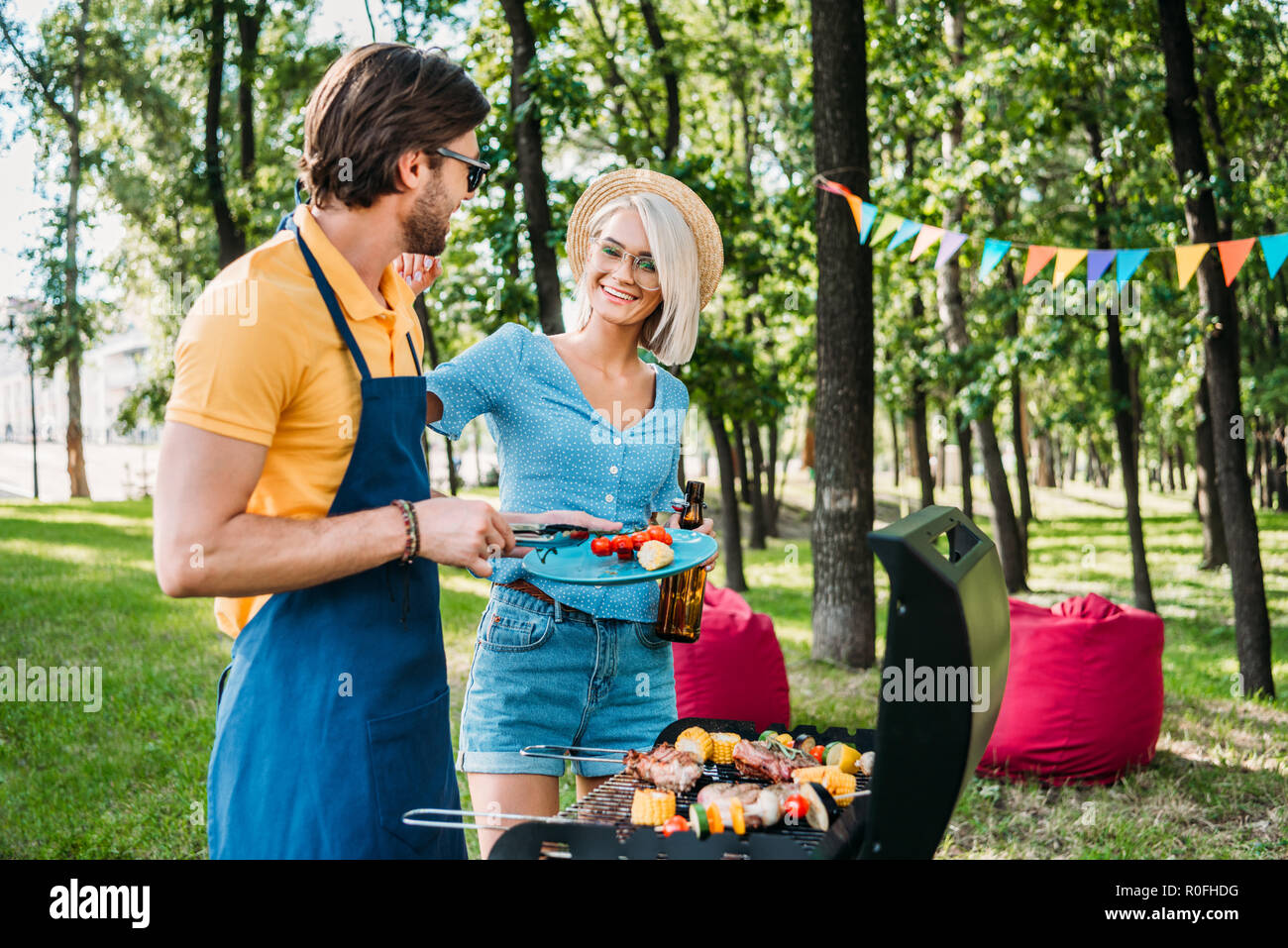 Couple at barbecue hi-res stock photography and images - Alamy
