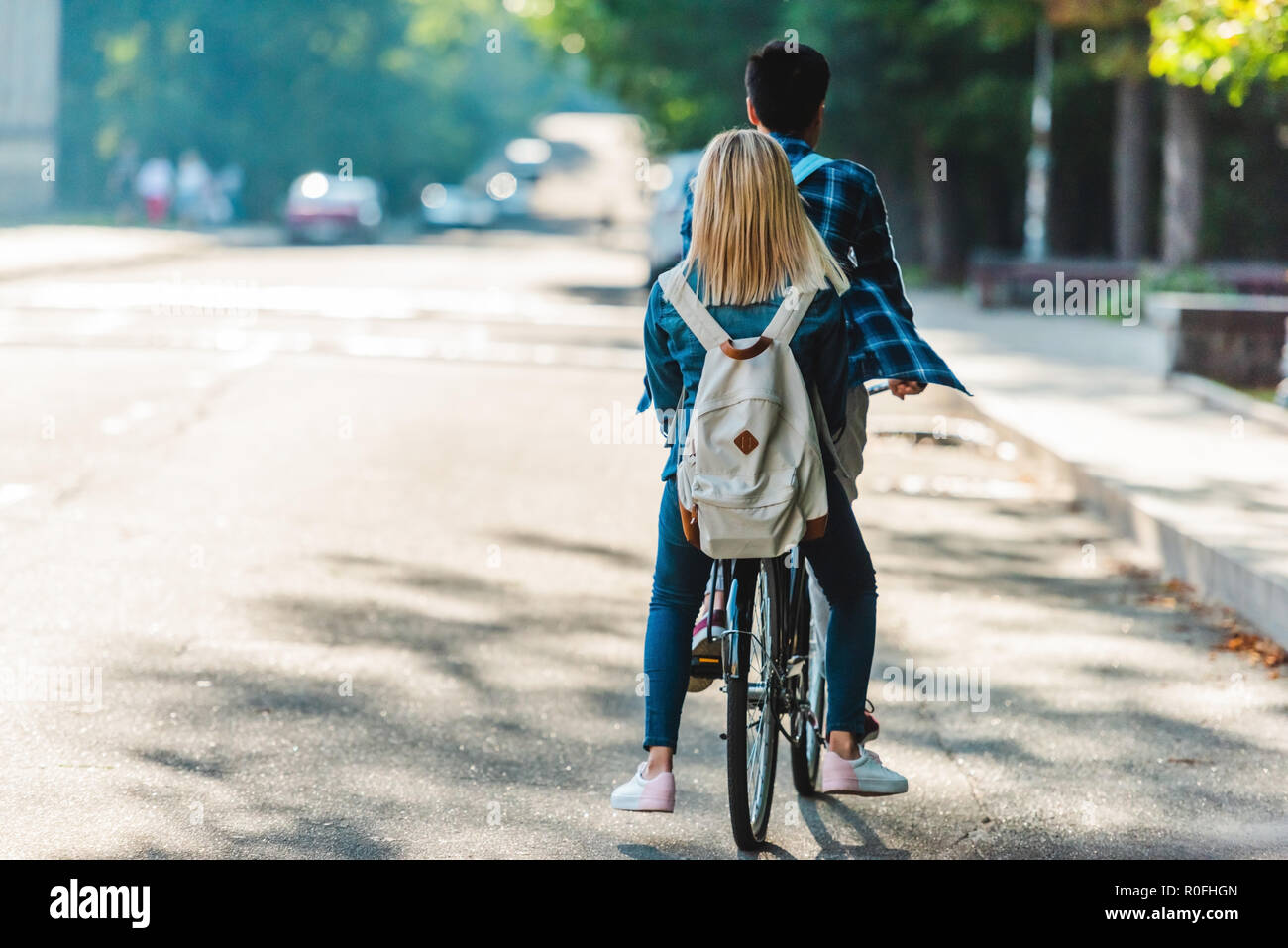 back view of students riding bicycle together on street Stock Photo - Alamy