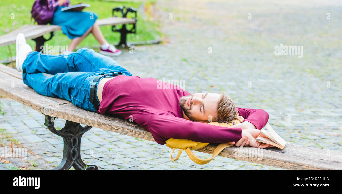 Woman sleeping on park bench hi-res stock photography and images - Alamy