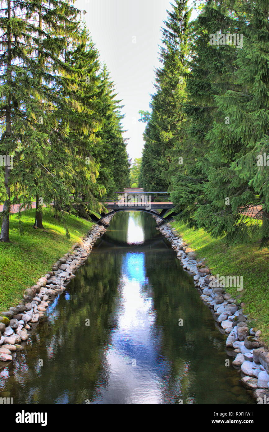 Water channel flanked by two tree avenues in a park Stock Photo - Alamy