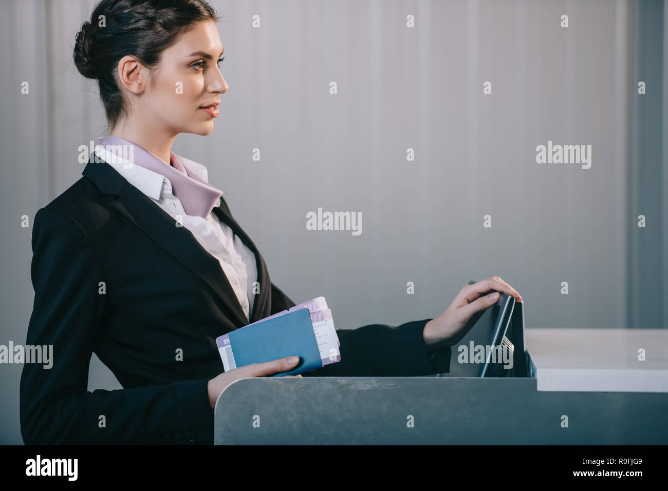 Female check in desk staff hi-res stock photography and images - Alamy