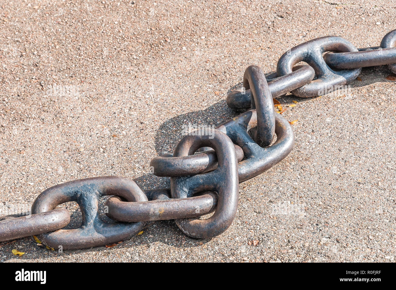 Chain for anchor from metal heavy iron on a gray background with a ...