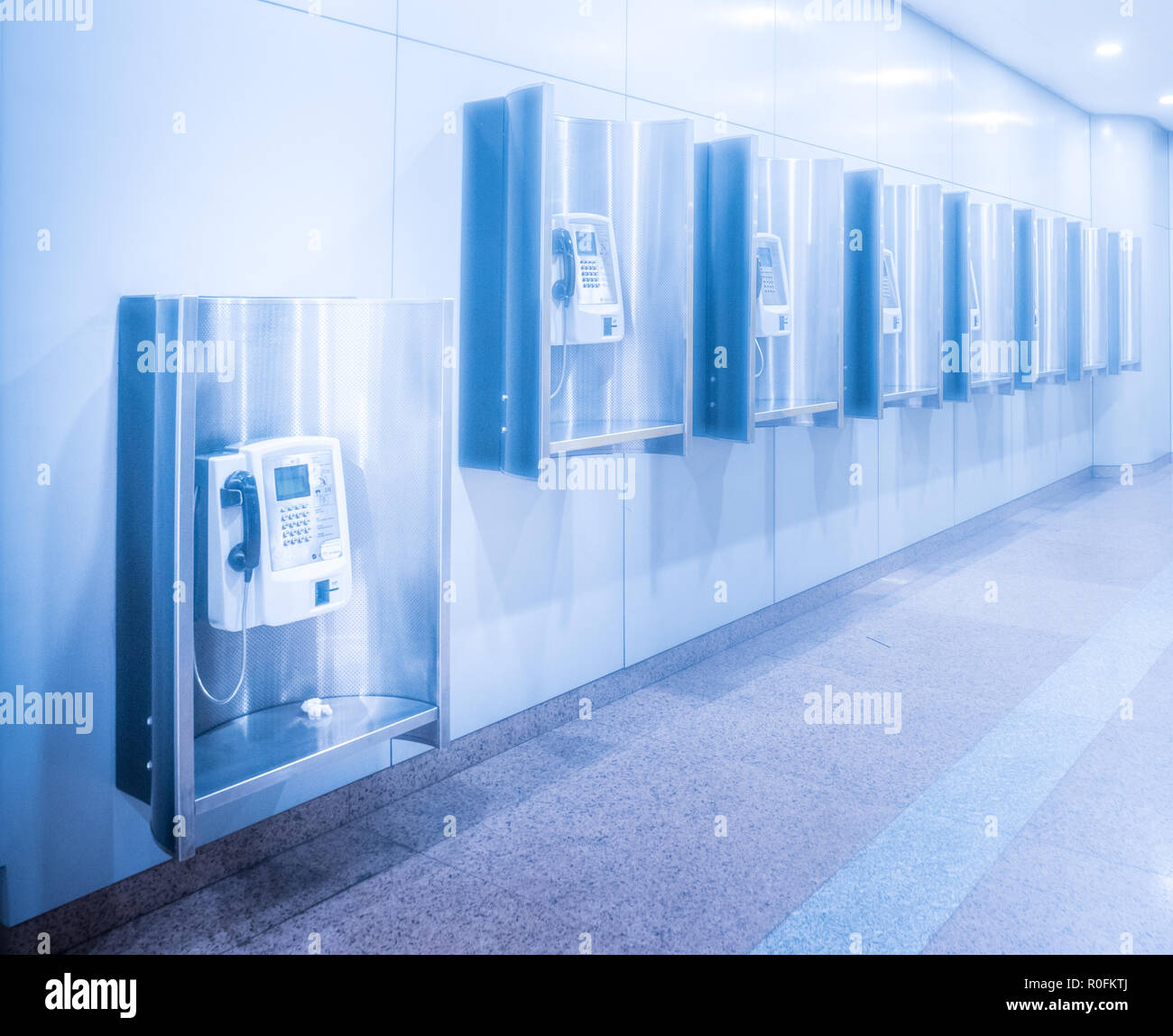 Perspective row of public telephone inside modern building Stock Photo ...