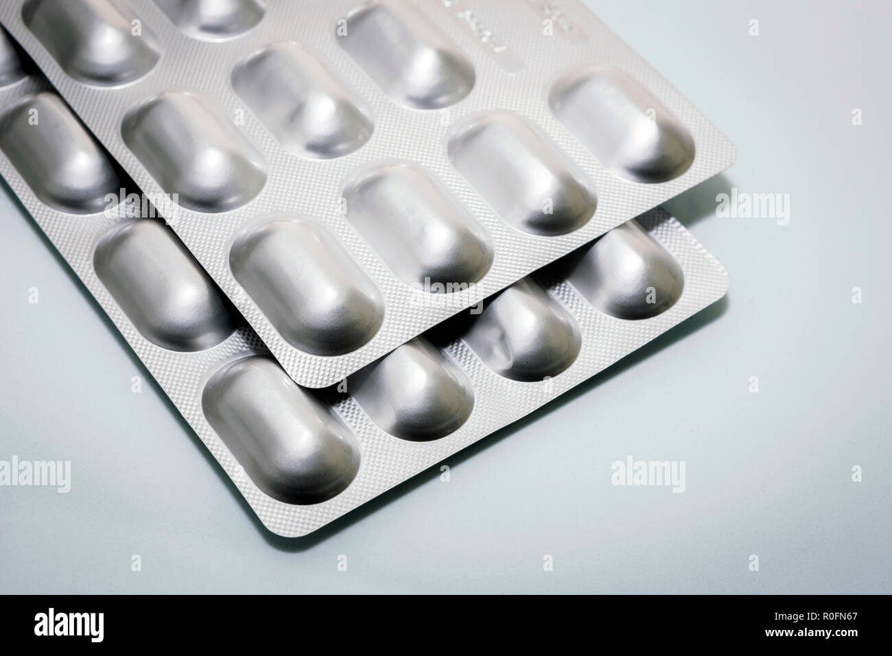 Packages silver pads on white background Stock Photo - Alamy