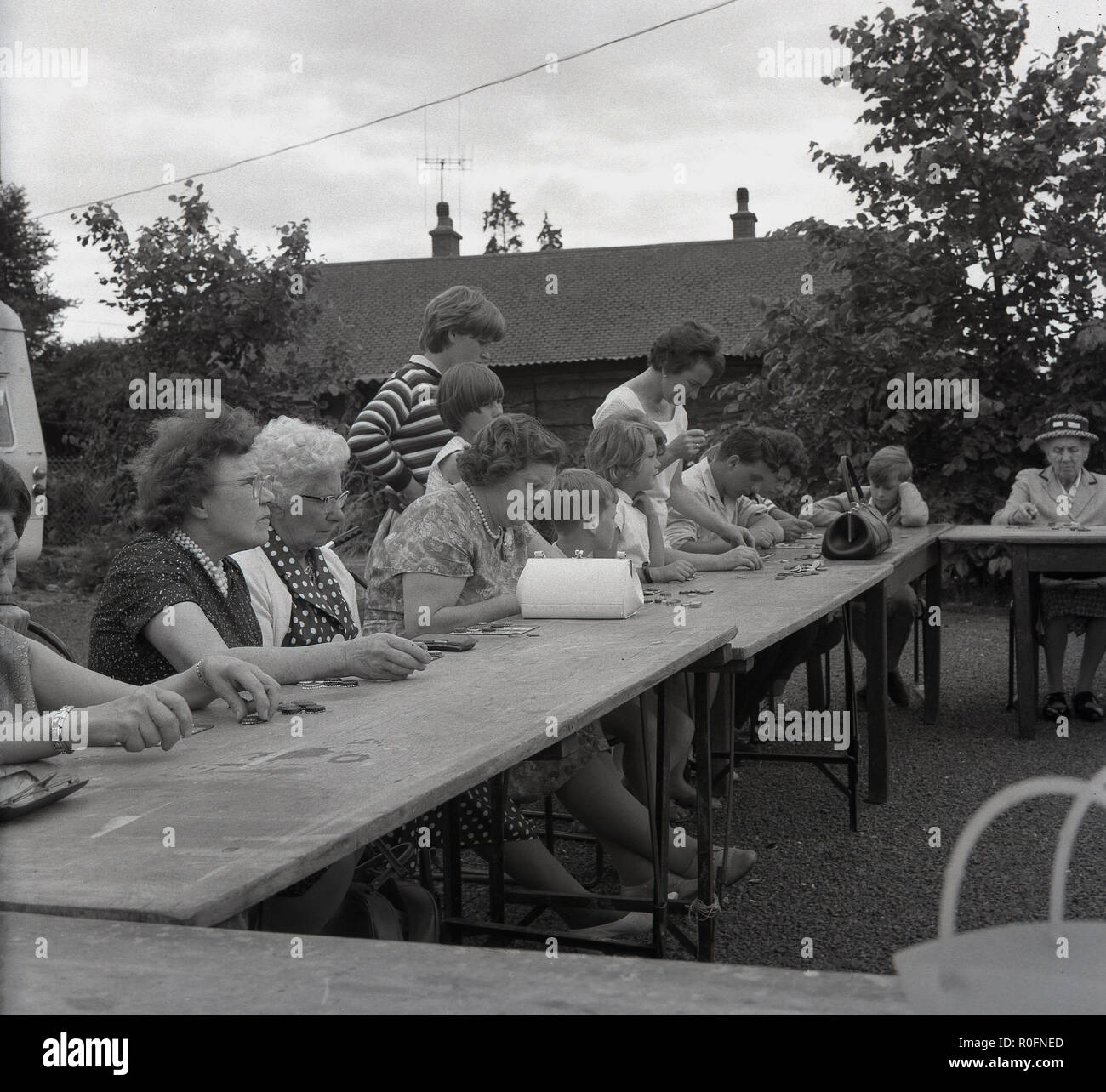 1964, adults and children attending an English village charity fete ...