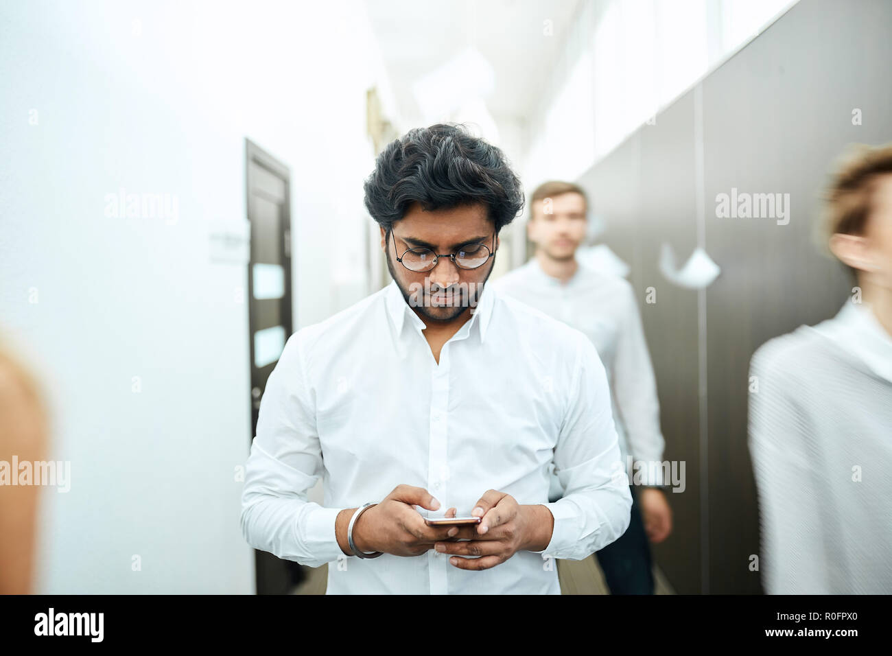 attractive mixed arce man surfing the net going to the meeting Stock ...