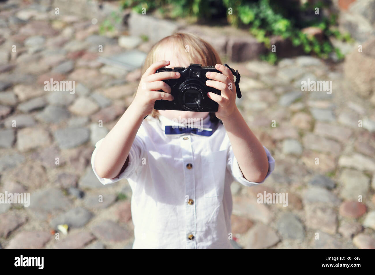 little photgrapher boy with camera in his hands Stock Photo - Alamy