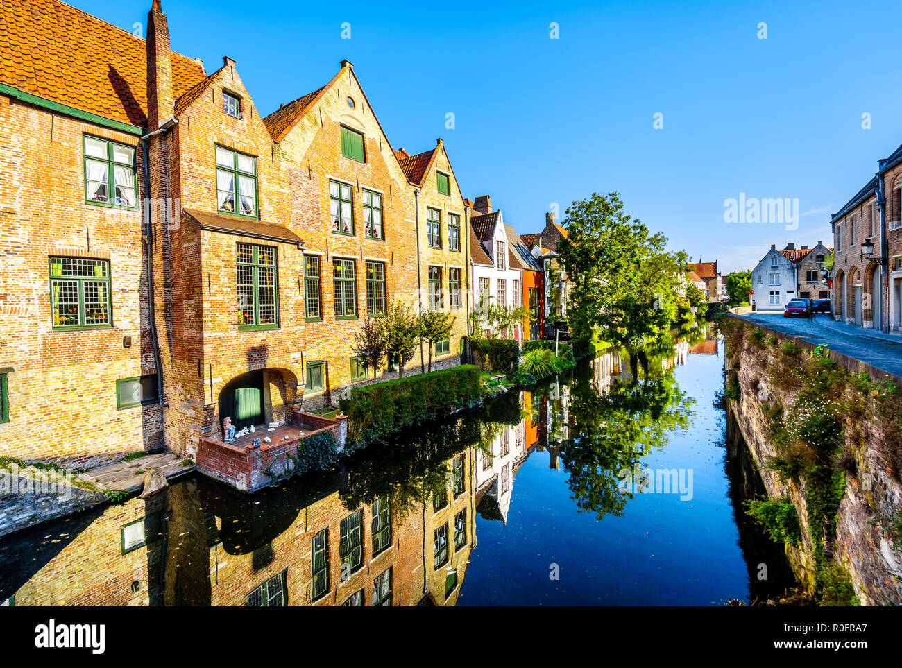 Reflections of medieval houses houses in the waters of one of the many ...