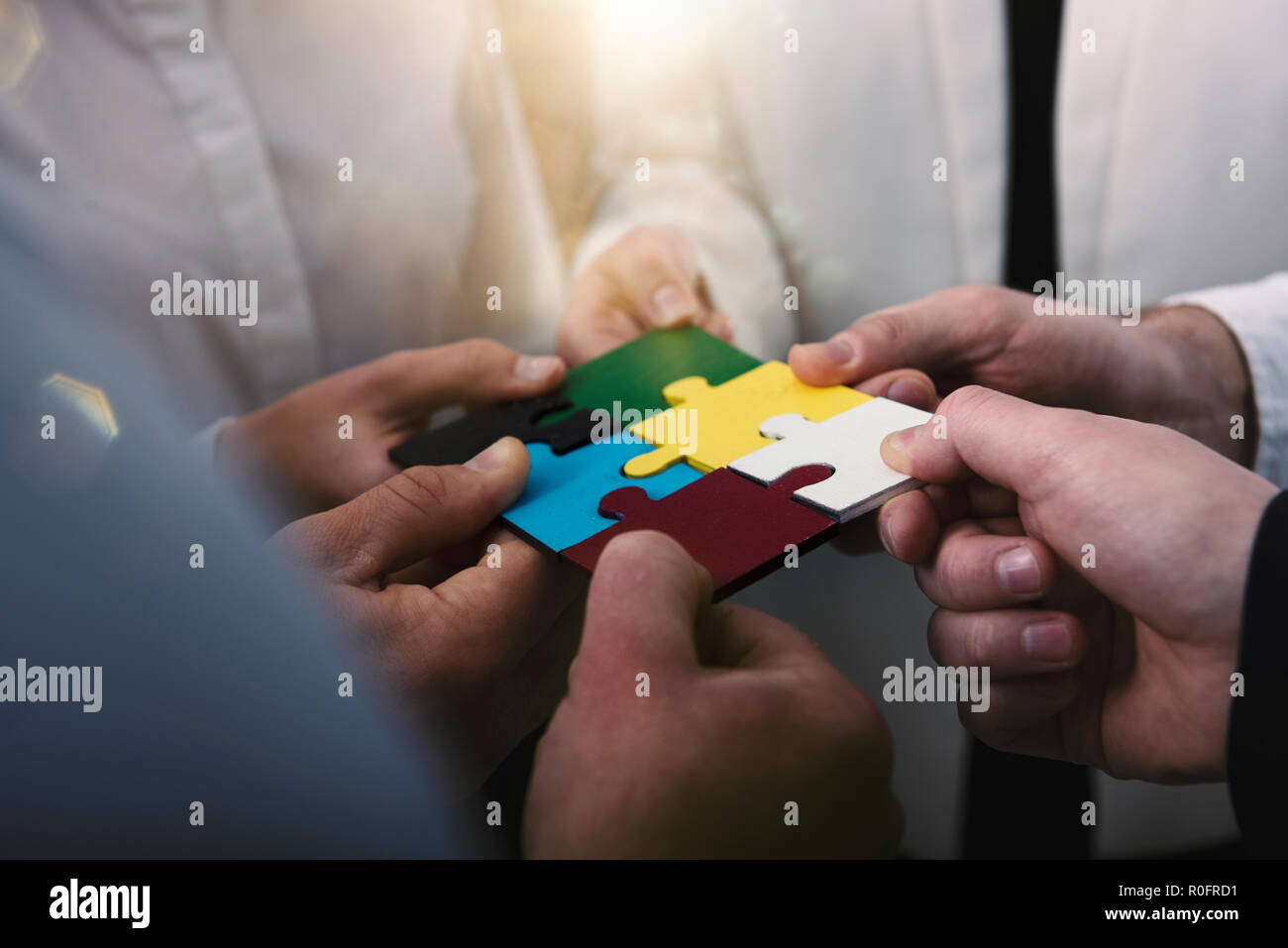 Teamwork of partners. Concept of integration and startup with puzzle ...