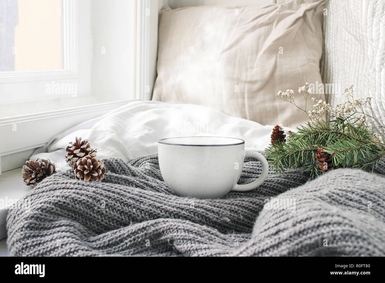 Cozy winter morning breakfast in bed still life scene. Steaming cup of ...