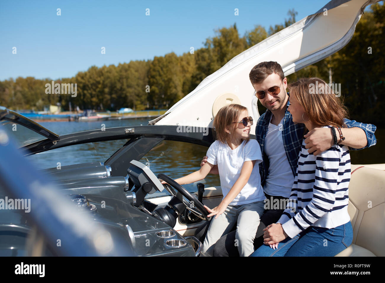 father with adorable daughter and wife resting on big boat Stock Photo ...