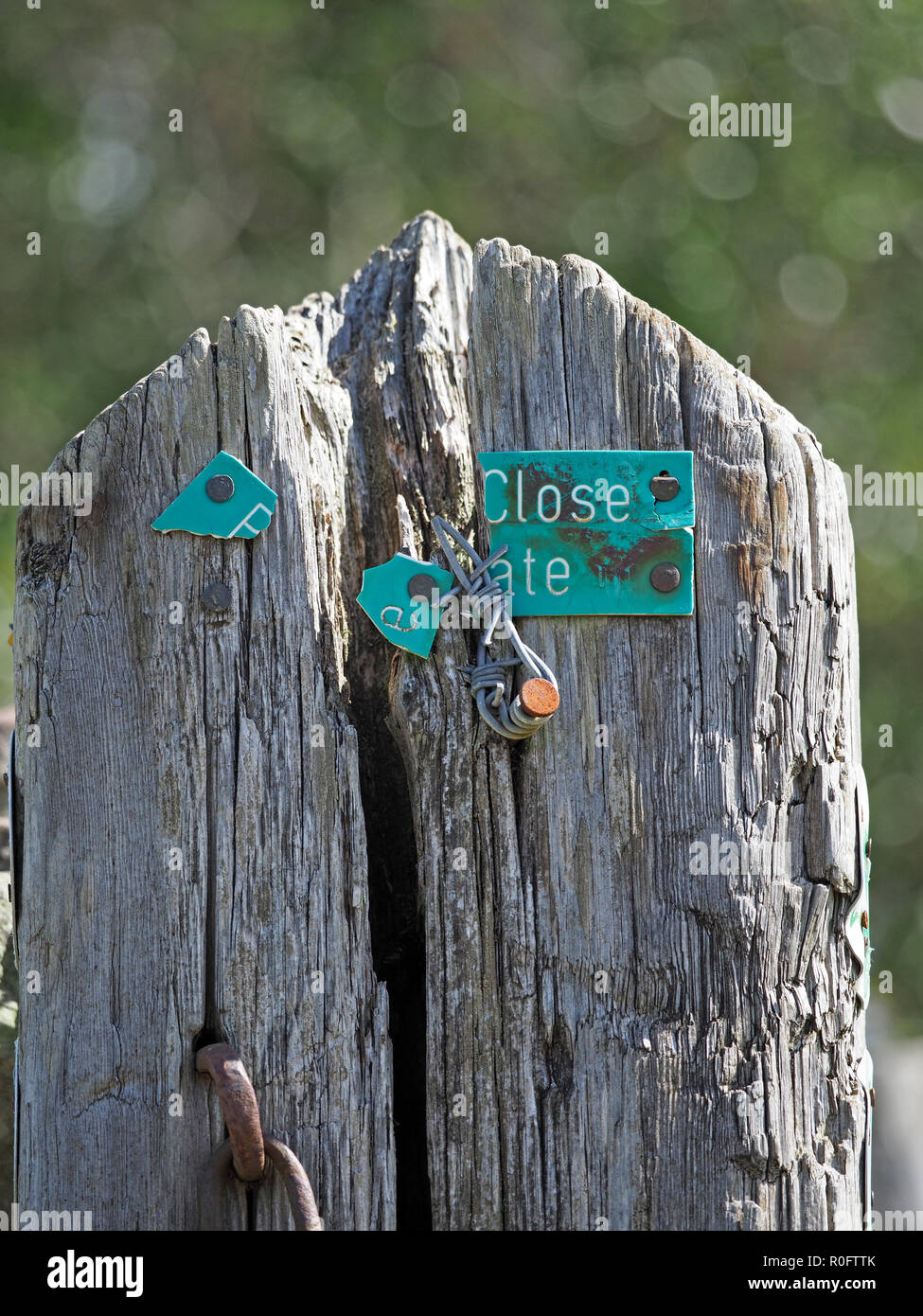 weathered and worn gatepost in Cumbria, England, UK with broken blue ...