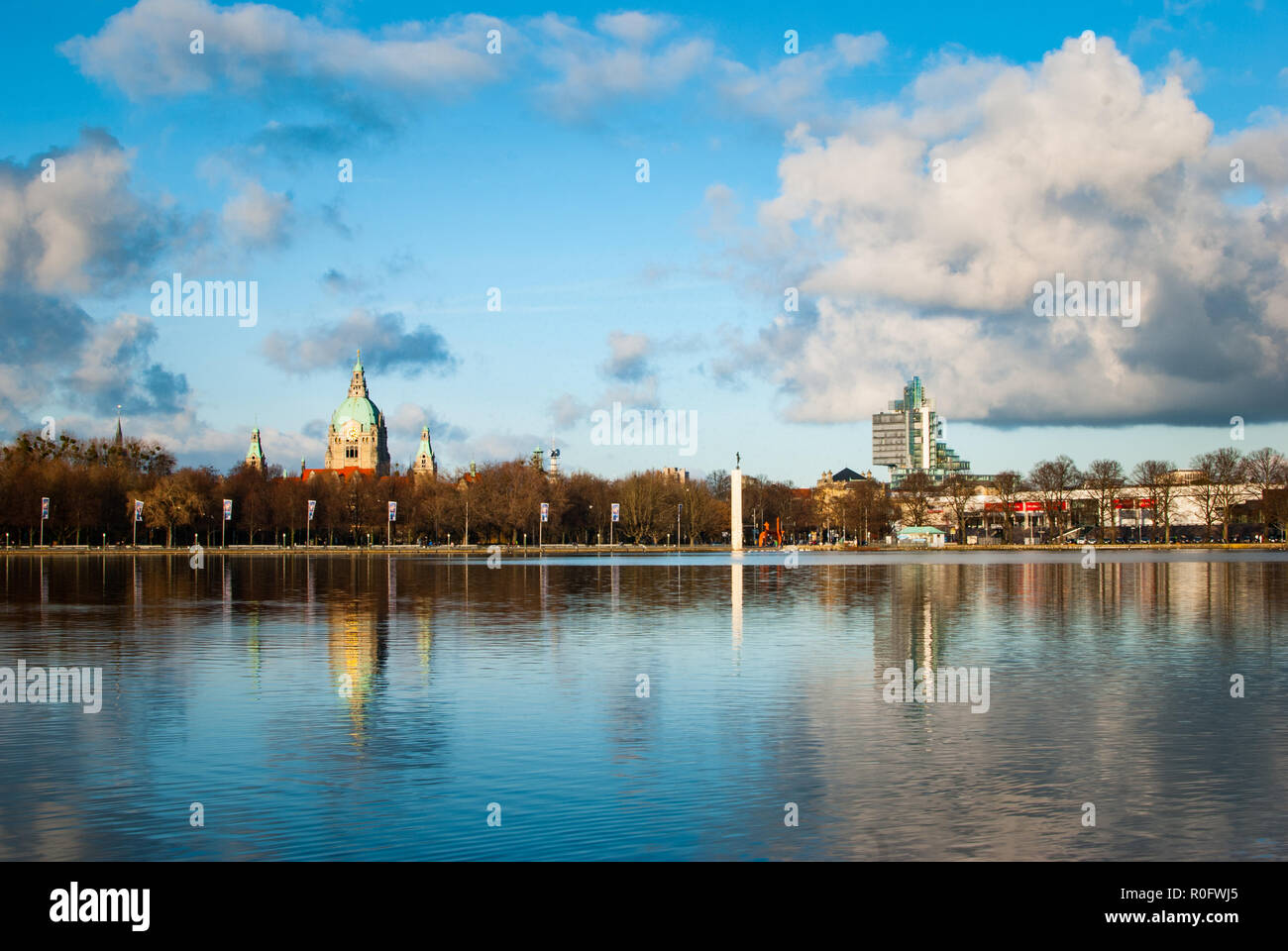 A panorama showing the town hall, a skyscraper, a cloudy blue sky and ...