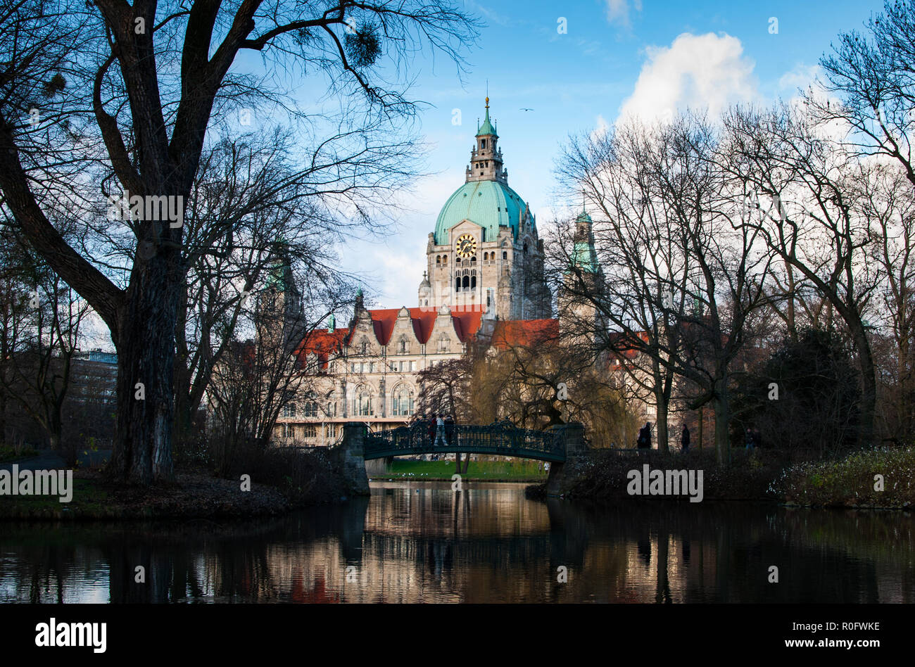 The town hall of hanover and it's garden reflected in the water in ...