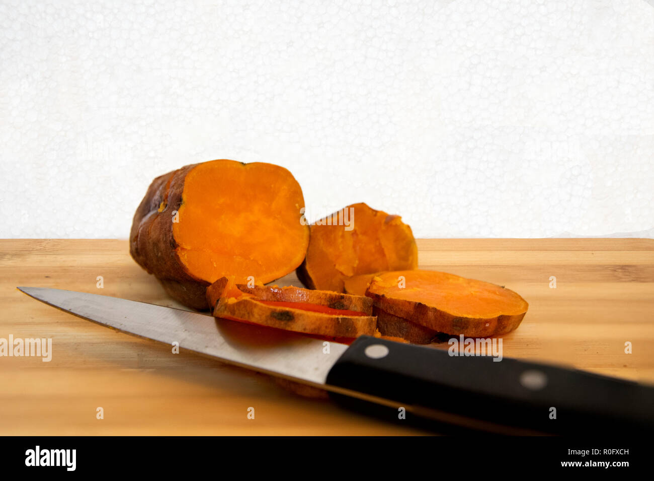 Cutting sweet potato into slices Stock Photo - Alamy