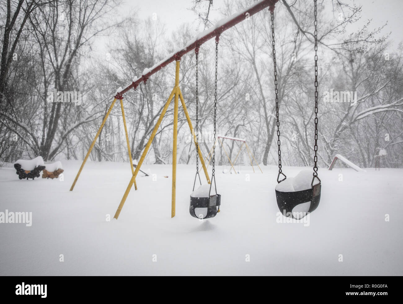 Playground equipment buried in snow during a blizzard that left over ...