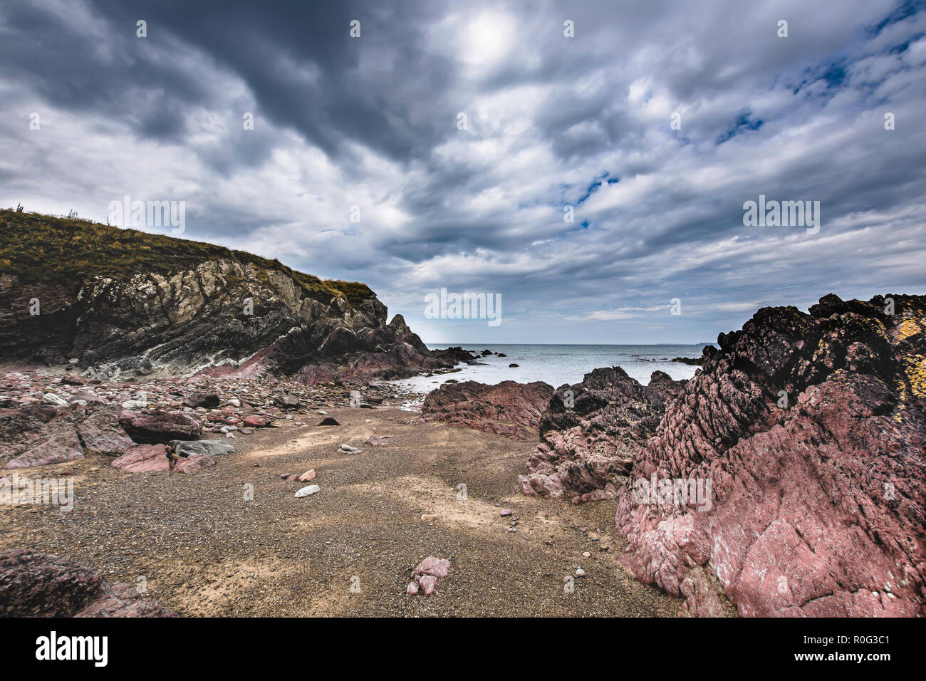 Landscape,UK.Cloudy sky over scenic rocky beach during low tide on beautiful Pembrokeshire coast ...