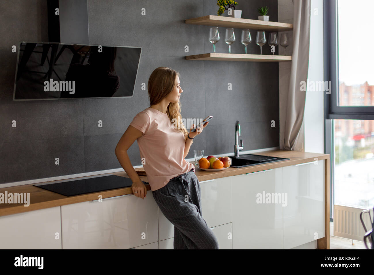 pensive awesome woman in the kitchen writing text message Stock Photo ...
