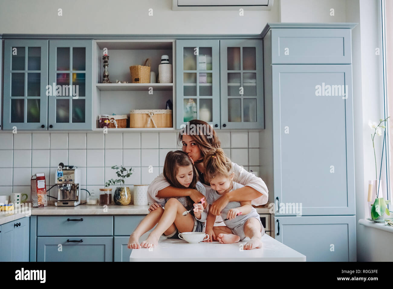 Happy family having fun in the kitchen Stock Photo - Alamy