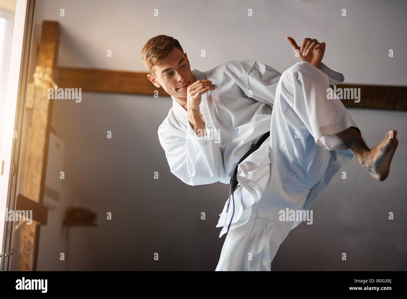 black belt karate fighter training hight kick Stock Photo - Alamy