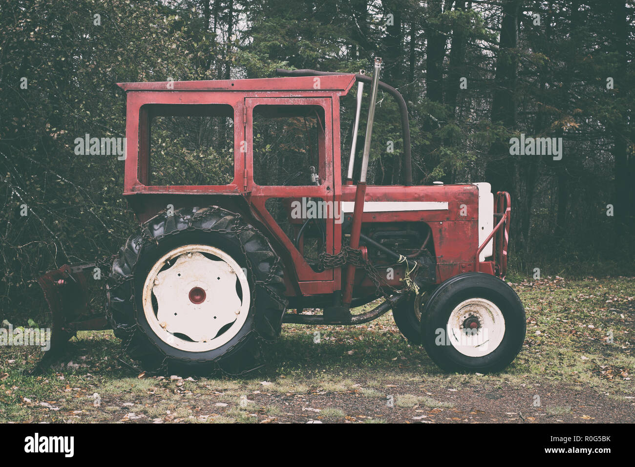 Vintage farm tractor profile view. Faded look Stock Photo - Alamy