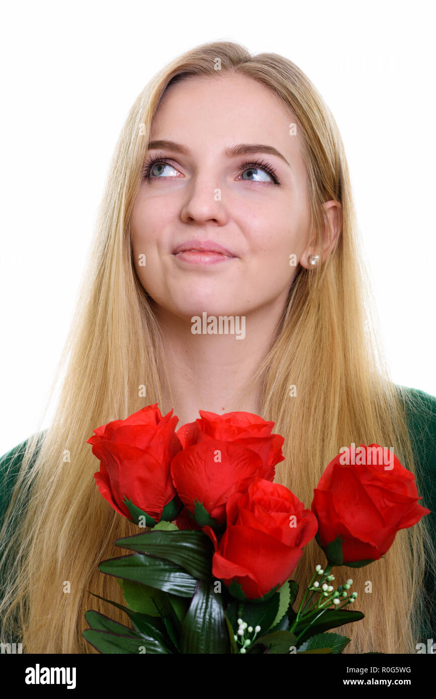Face of thoughtful teenage girl holding red roses ready for Vale Stock ...