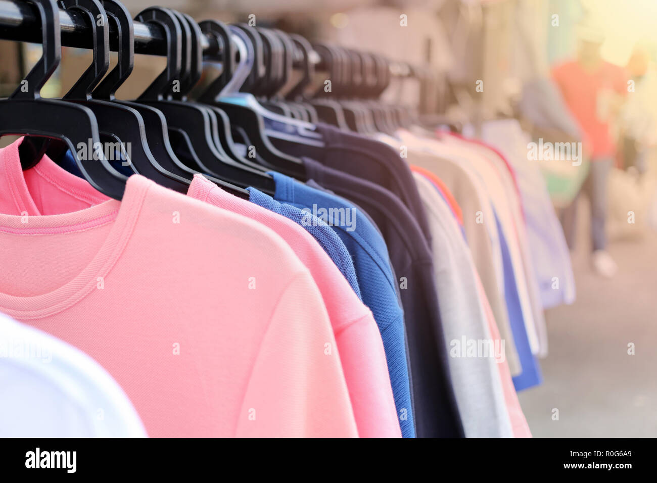 Colorful clothes hanging on clothesline and have orange sunlight shines ...