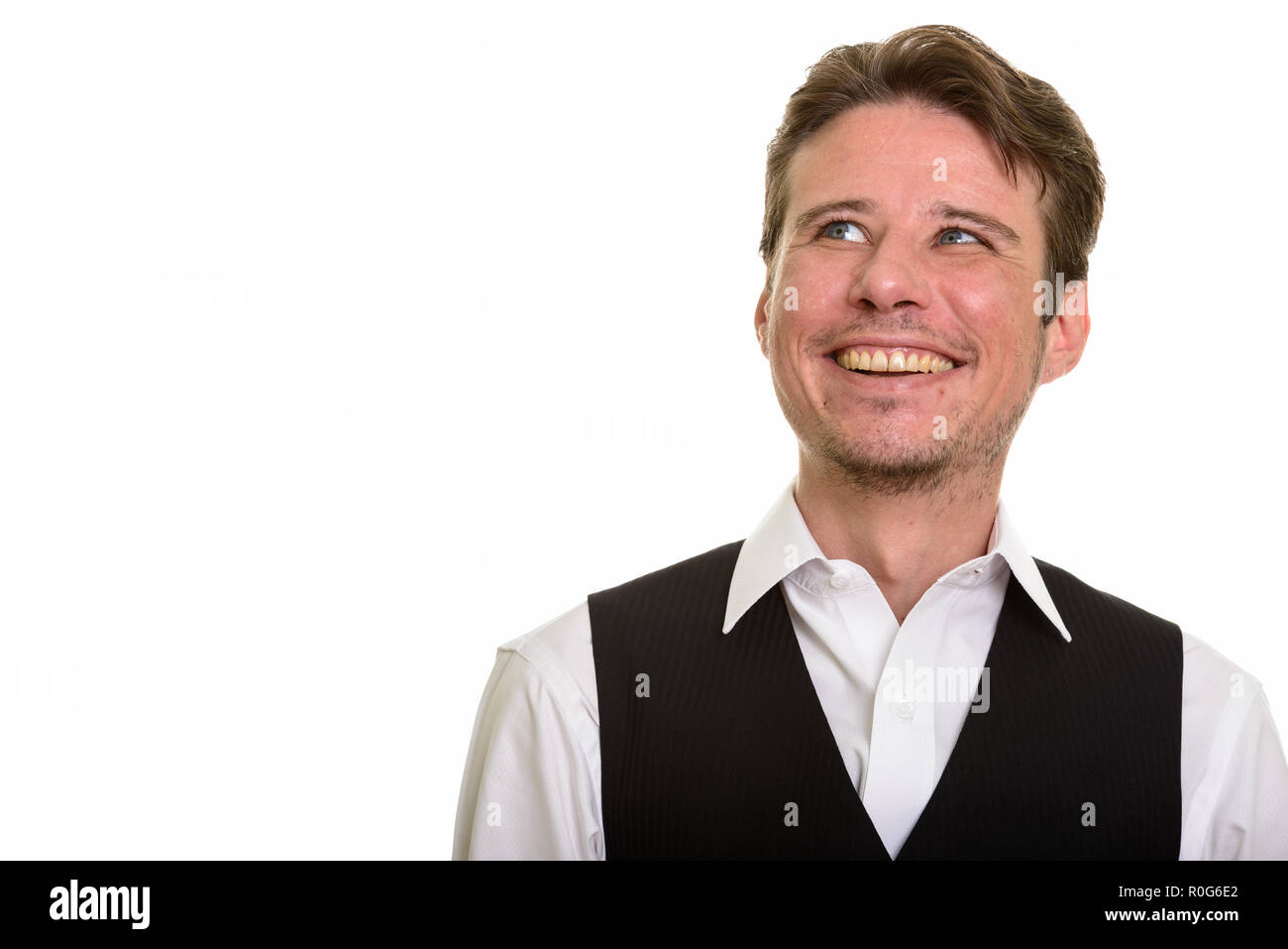 Happy formal Caucasian man thinking wearing vest Stock Photo - Alamy