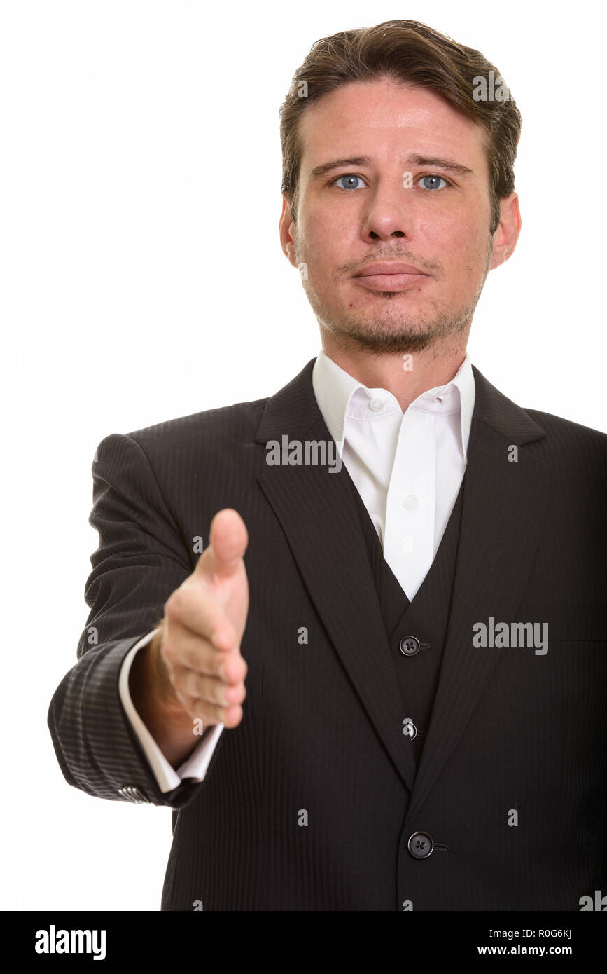 Caucasian businessman giving handshake while looking at camera Stock ...