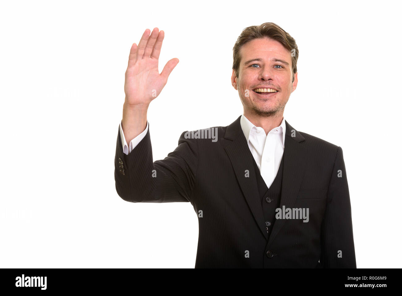 Happy Caucasian businessman waving hand and looking at camera Stock ...