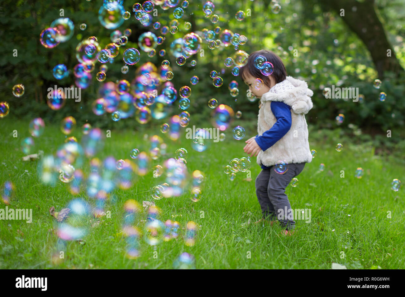 baby girl play bubble at Spring garden Stock Photo - Alamy