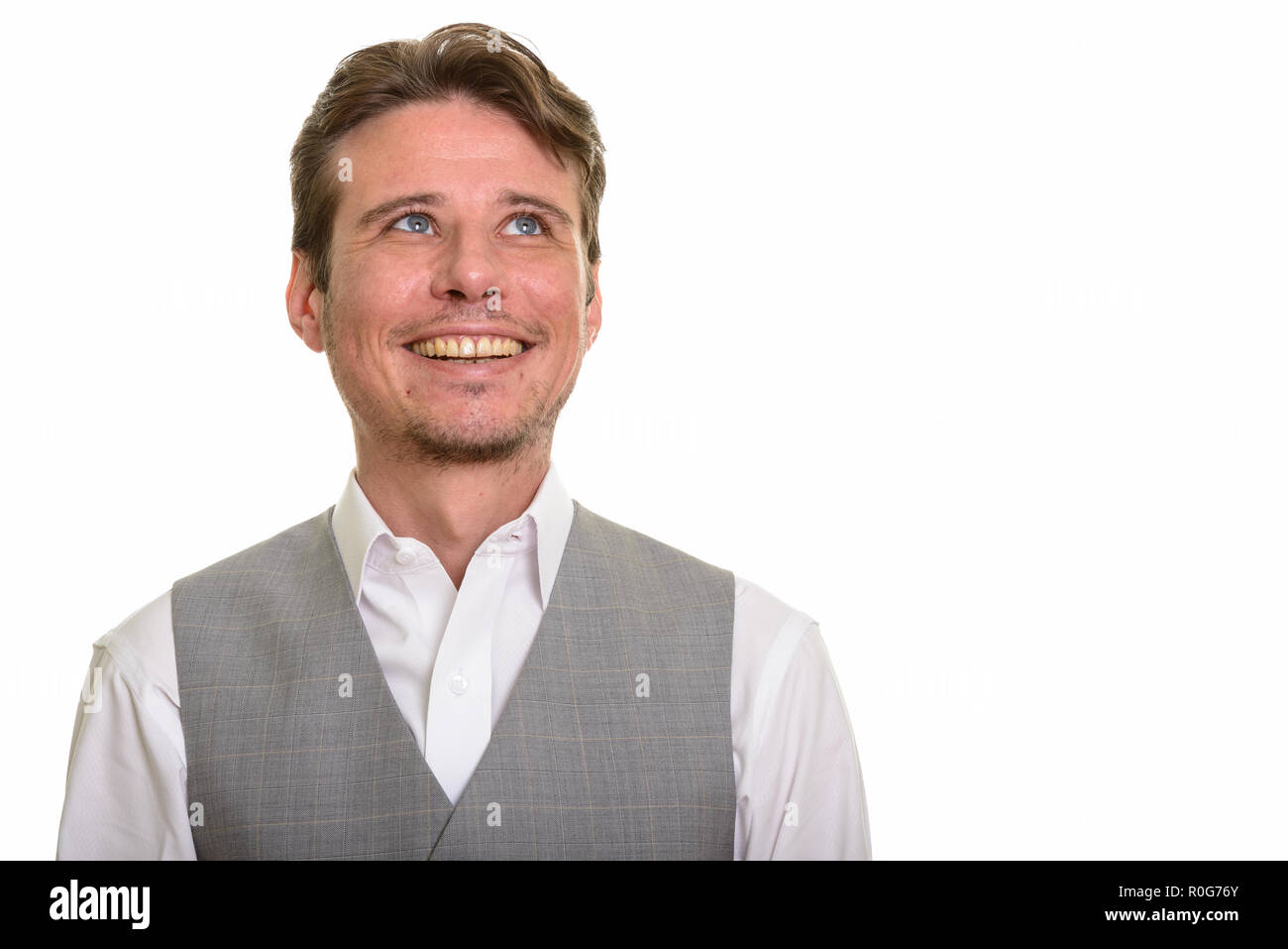 Happy formal Caucasian man thinking wearing vest Stock Photo - Alamy