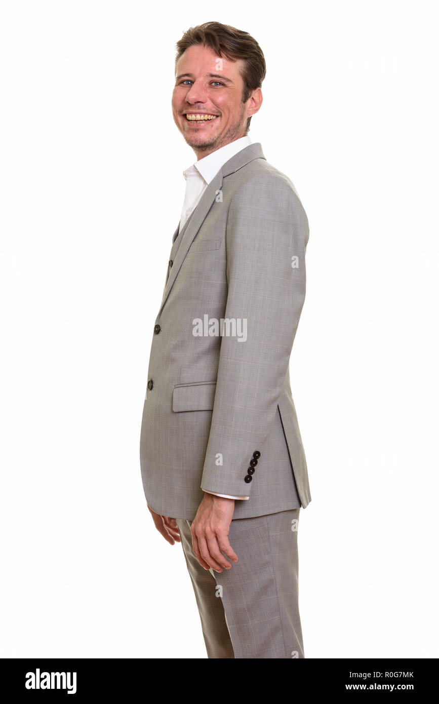 Side view of happy Caucasian businessman looking at camera Stock Photo ...