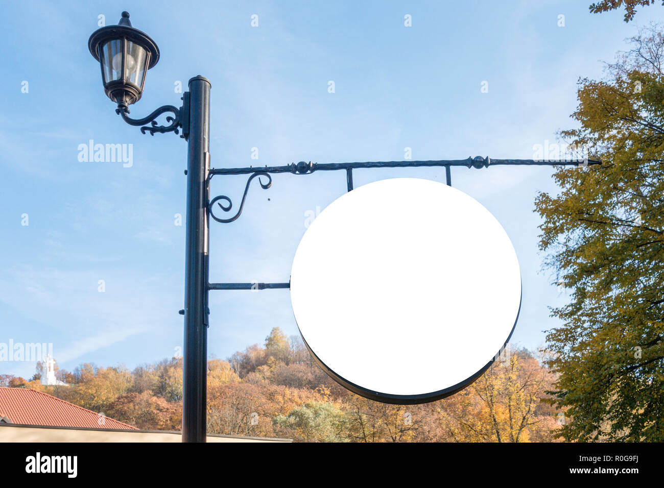 Blank round signboard, advertising, information board on pole in the ...